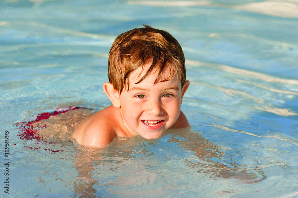 Boy in a swimming pool Stock Photo | Adobe Stock