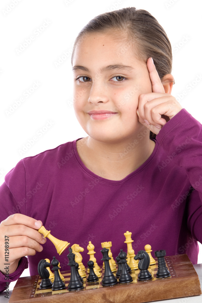 Attractive little girl playing chess Stock Photo | Adobe Stock
