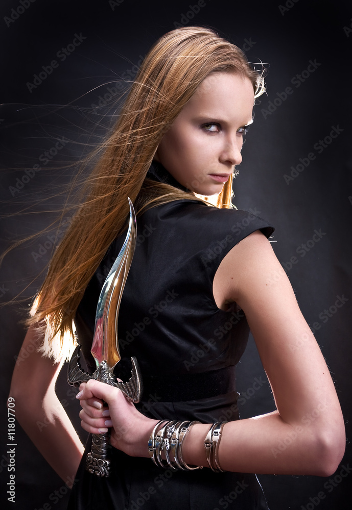 blond young girl holding dagger Stock Photo | Adobe Stock