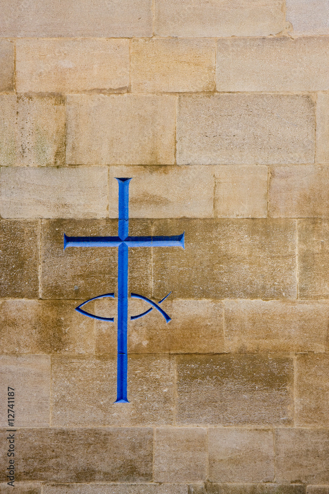 Engraving of a cross and fish in a stone wall Stock Photo | Adobe Stock