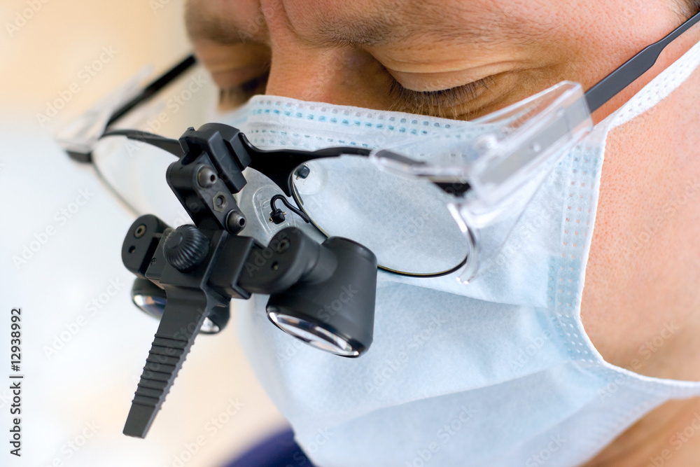 surgeon with binocular glasses Stock Photo | Adobe Stock