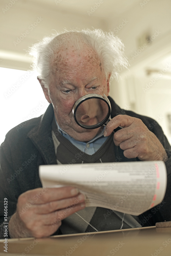 Old man with a magnifying glass Stock Photo | Adobe Stock