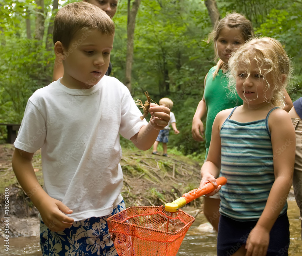 children playing in a stream with nets Stock-Foto | Adobe Stock