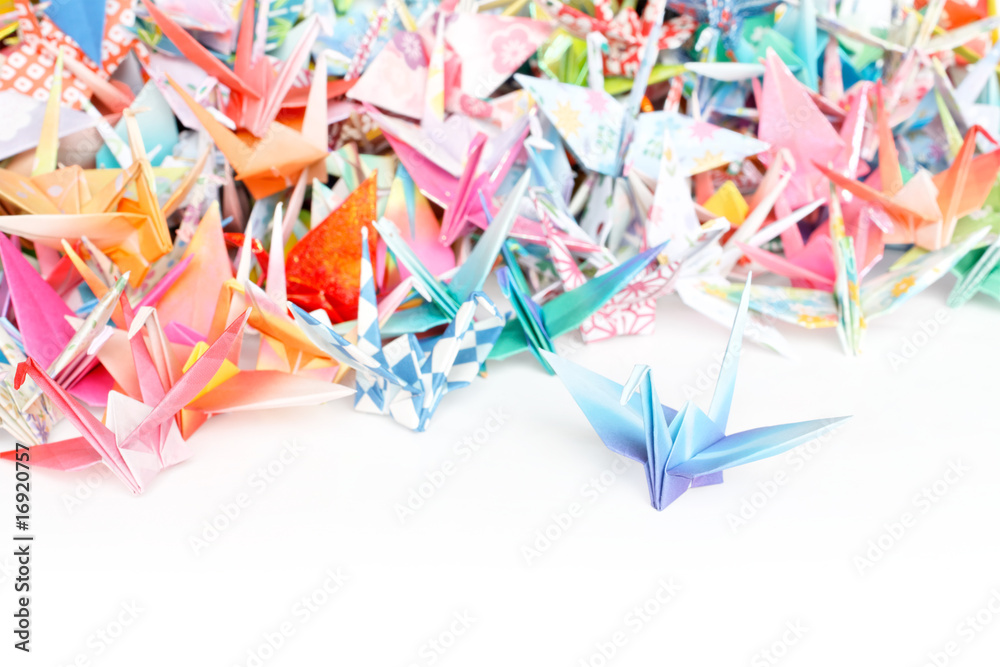 A blue paper crane separated from a pile of paper cranes Stock Photo ...