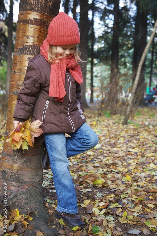 cute little girl standing near the tree in the park Stock Photo | Adobe ...