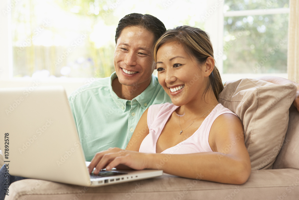 Young Couple Using Laptop At Home Stock Photo | Adobe Stock