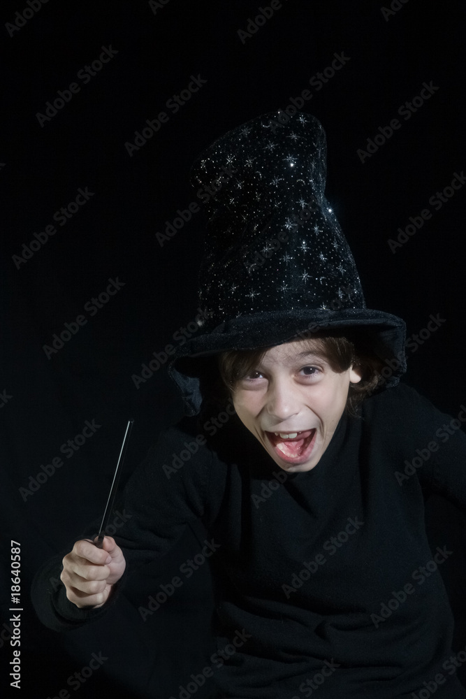 boy with magic wand on black background Stock-Foto | Adobe Stock