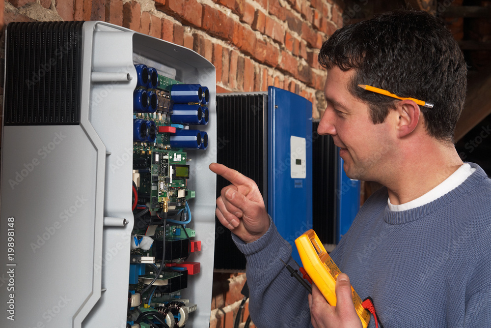 expert at the photovoltaic inverters of a solar plant 01 Stock Photo ...