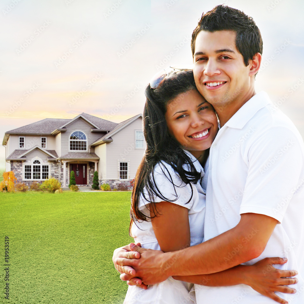 Happy Couple In Front Of House