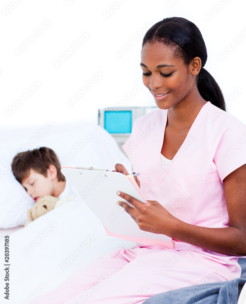 Afro-american doctor making notes on a patient's clipboard Stock Photo ...