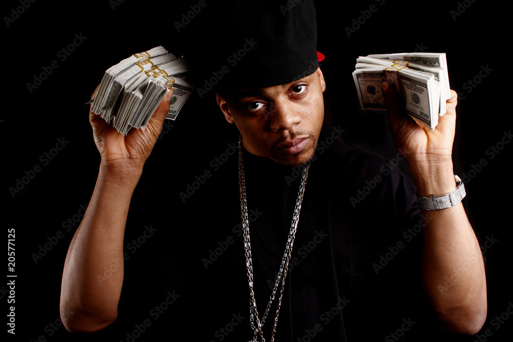 Foto de young black male with bundles of cash do Stock | Adobe Stock
