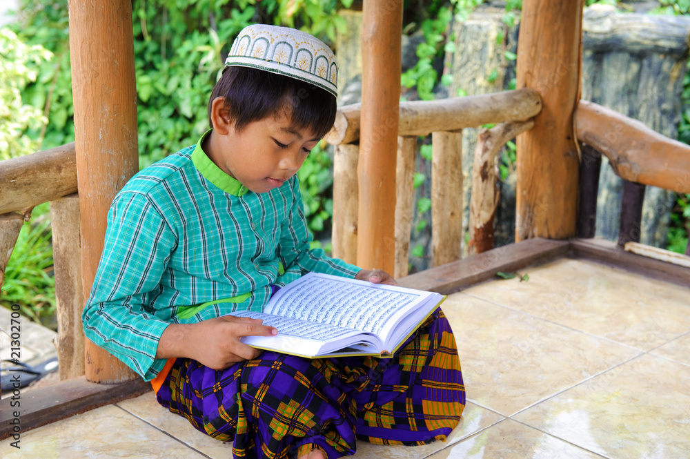 Muslim Boy Reading Koran Stock Photo | Adobe Stock