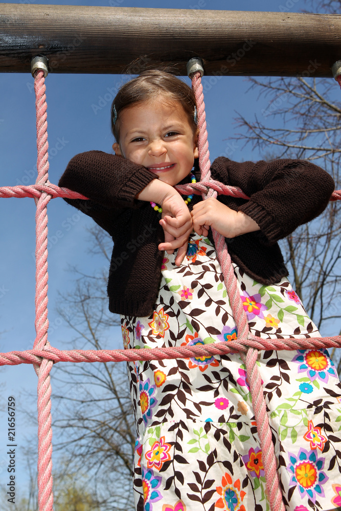 Young girl climbing up a rope ladder Stock Photo | Adobe Stock