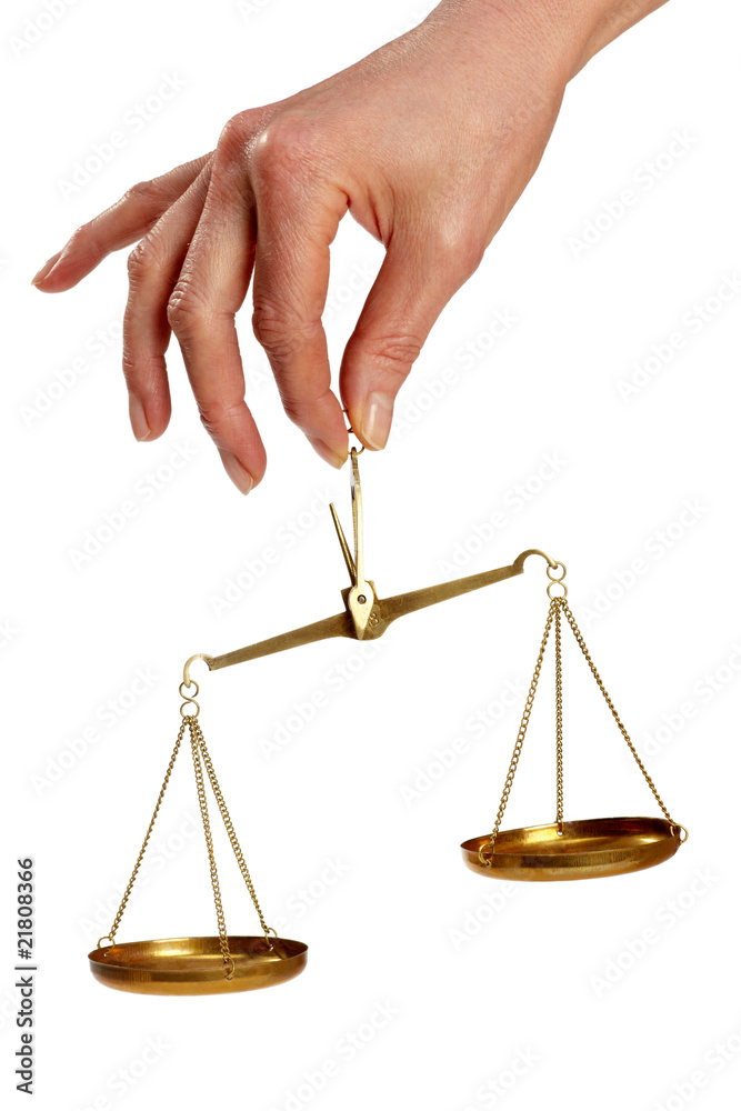 hand holding a pair of gold scales Stock Photo | Adobe Stock