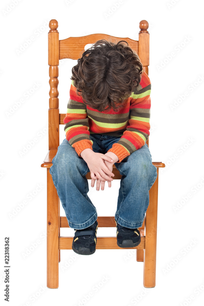 Sad child sitting on a chair isolated Stock Photo | Adobe Stock