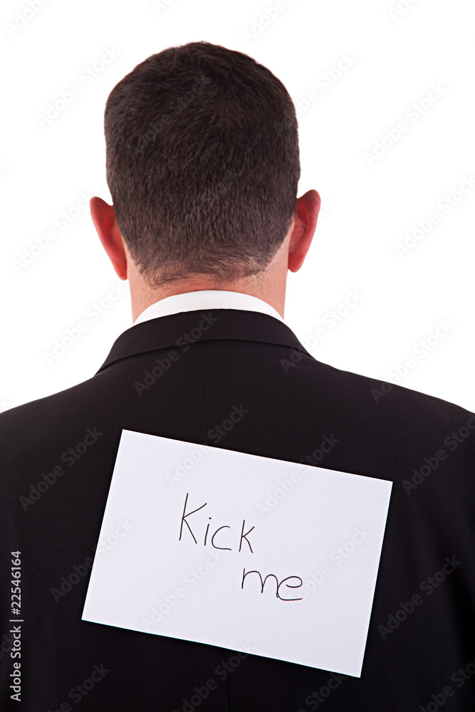 back of businessman, with kick me written in a paper Stock Photo ...