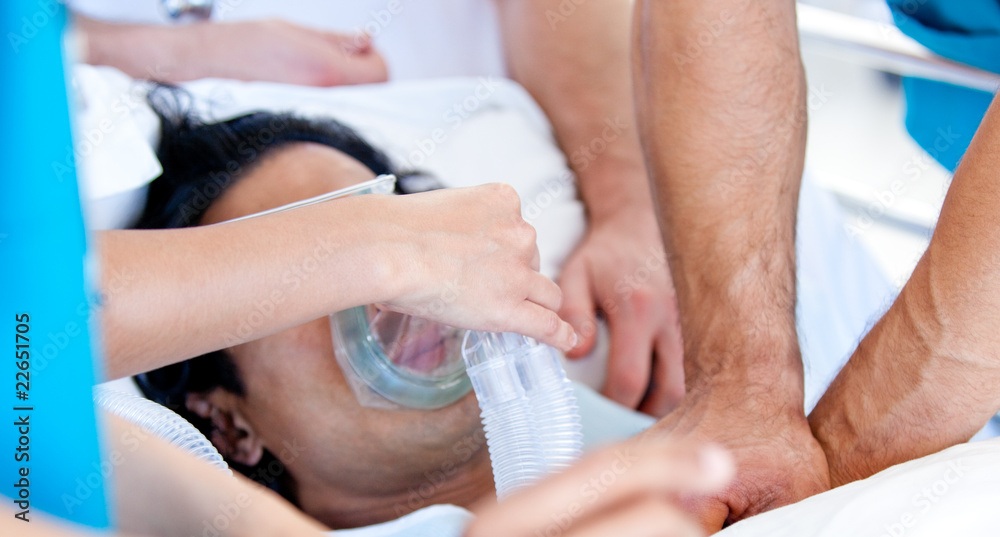 Medical team giving oxygen mask to the patient Stock Photo | Adobe Stock