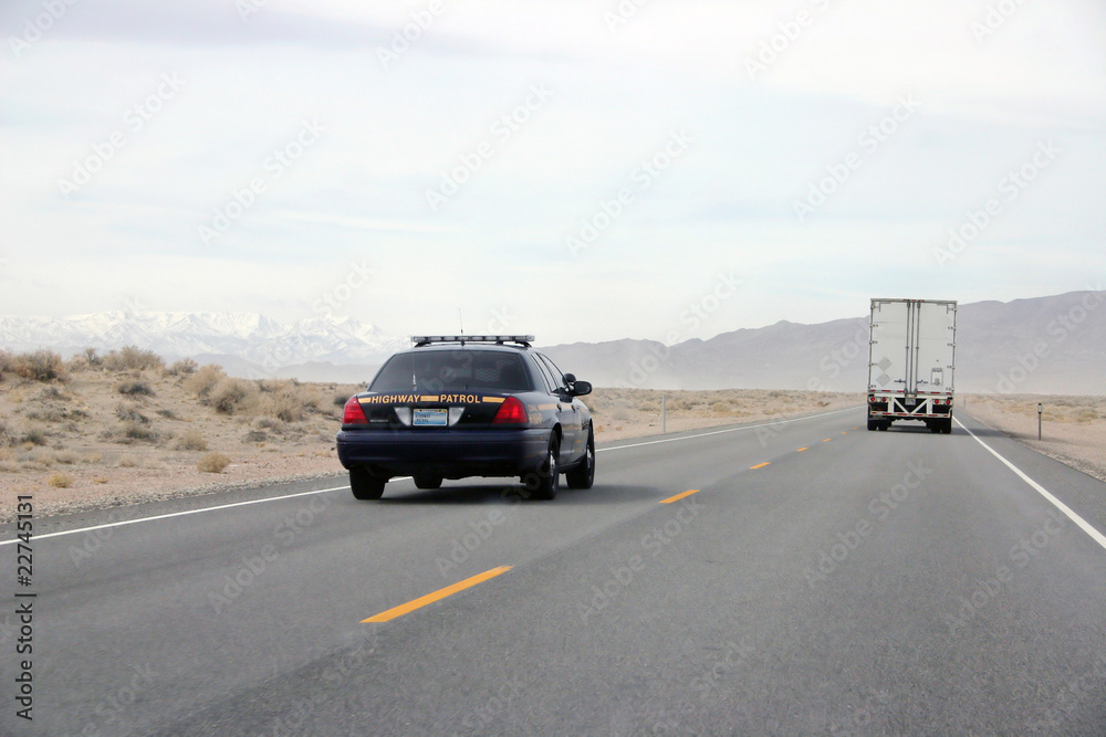 Police car patrol on high way cross desert. Stock Photo | Adobe Stock