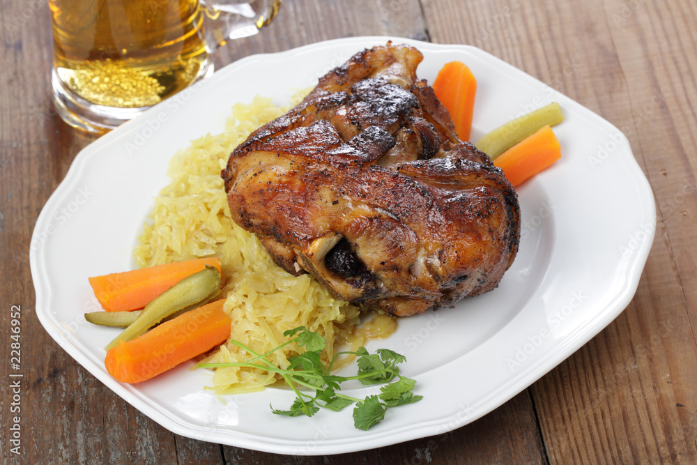 Eisbein, roasted pork knuckle with sauerkraut and beer Stock Photo ...