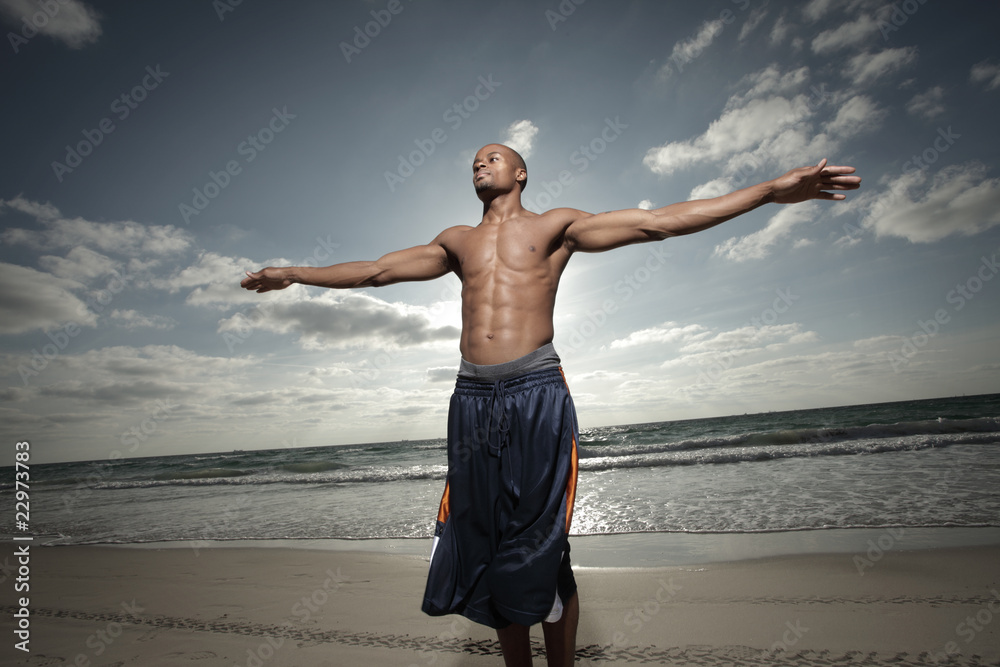 Vivid image of a man on the beach with arms outstretched Stock Photo ...