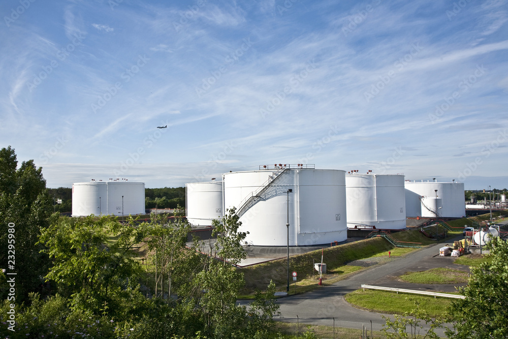 white tanks in tank farm with blue sky and aircraft Stock Photo | Adobe ...