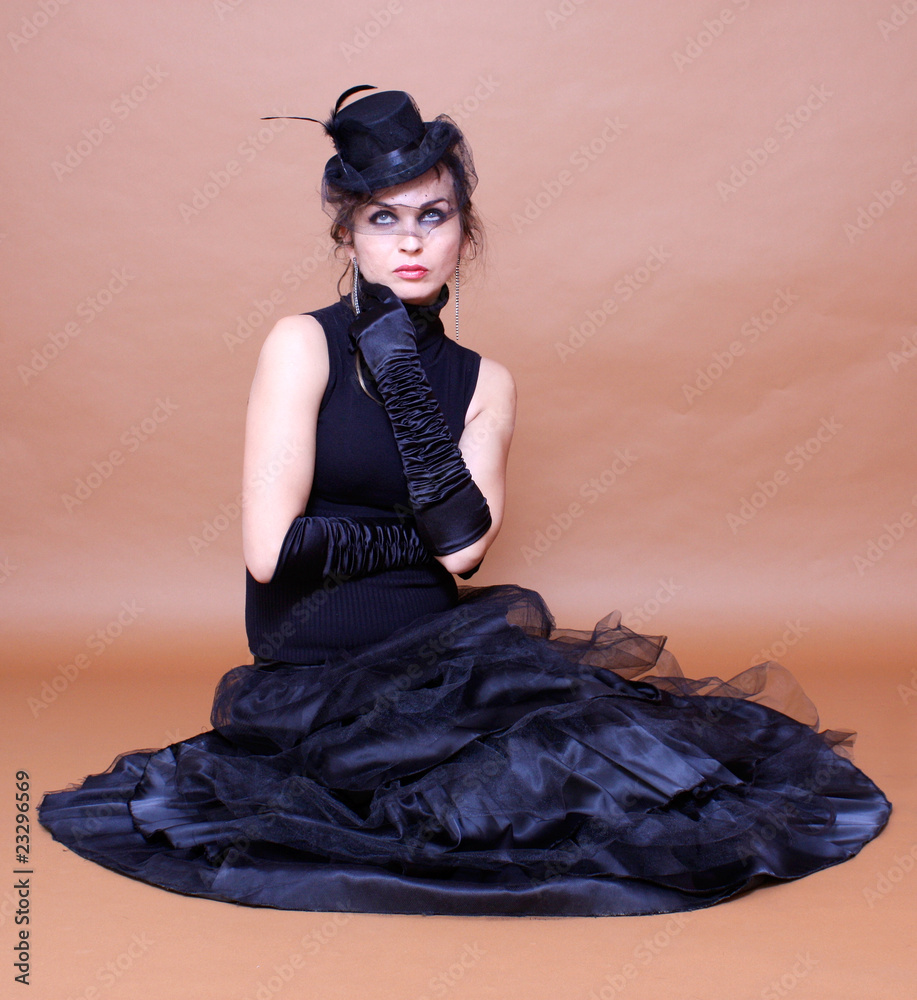 Gothic woman wearing black dress laying on the floor Stock Photo ...
