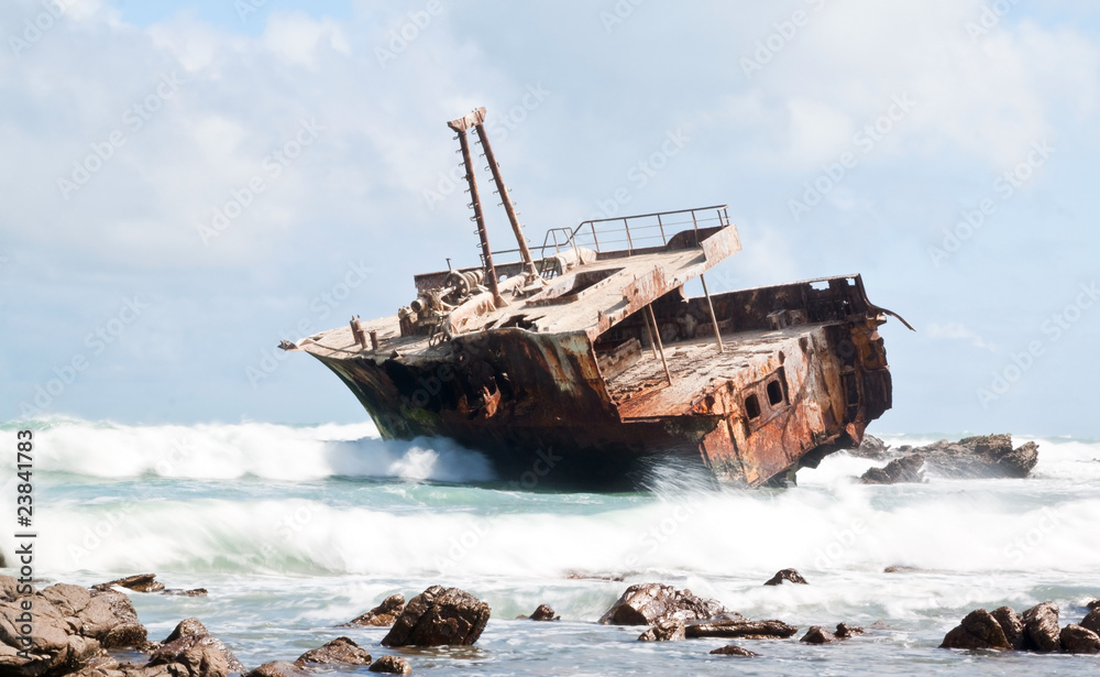 Aghullas shipwreck lying on the rocks in the breakers Stock Photo ...