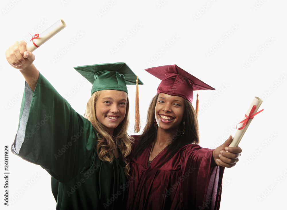 two female graduates in cap and gown with diplomas Stock Photo | Adobe ...