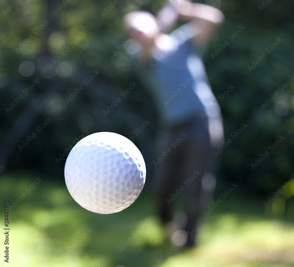 A golf ball in flight Stock Photo | Adobe Stock