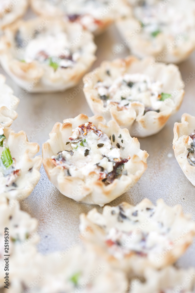 Uncooked mini goat cheese tarts ready for the oven. Stock Photo | Adobe ...