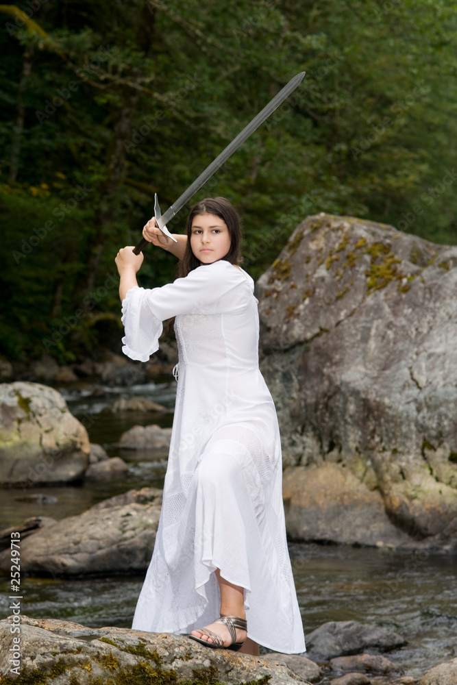 Young girl in white dress with two handed sword Stock Photo | Adobe Stock