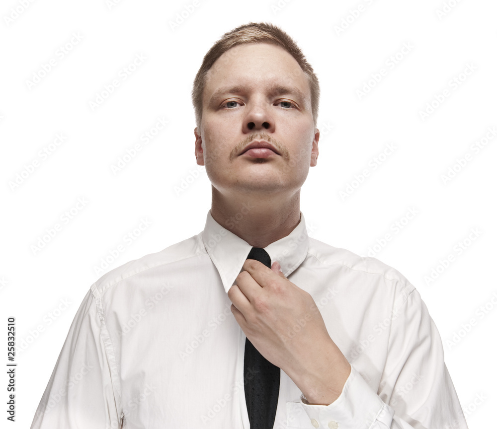 Serious looking man fixing his tie. Isolated on white. Stock Photo ...