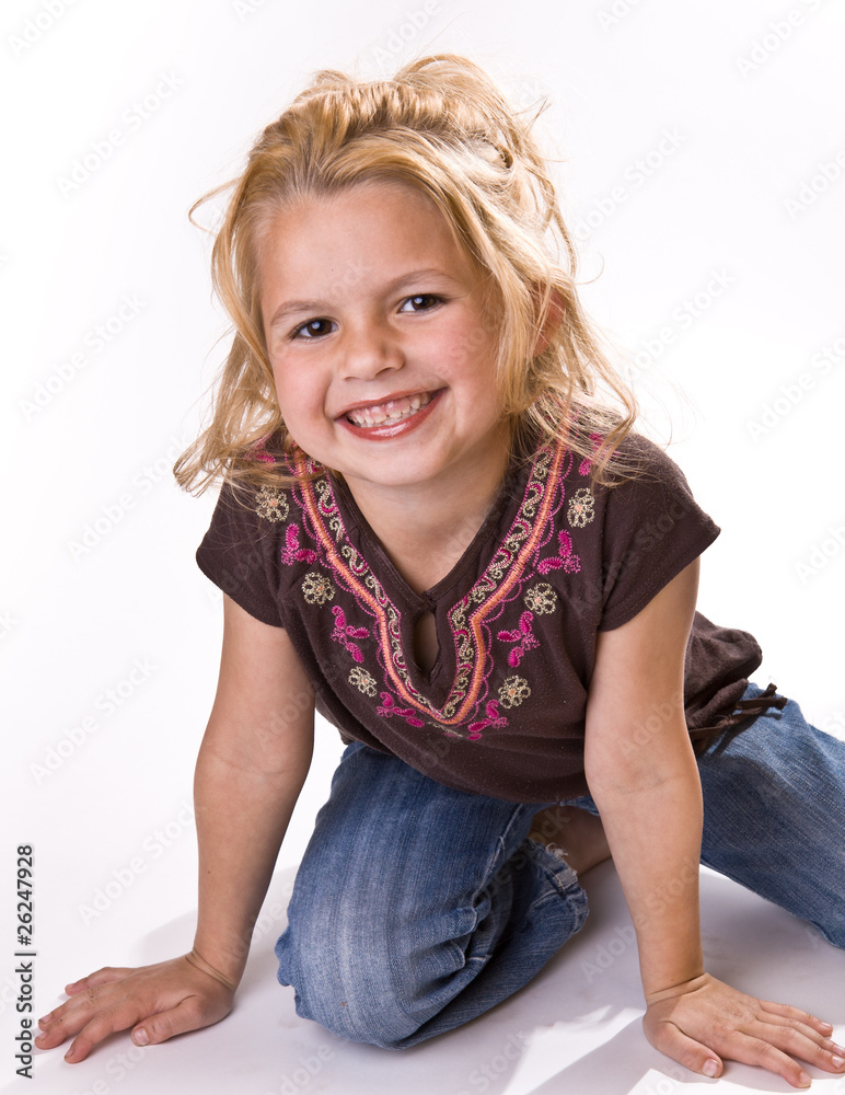 Adorable little girl on her knees smiling at the viewer Stock Photo ...