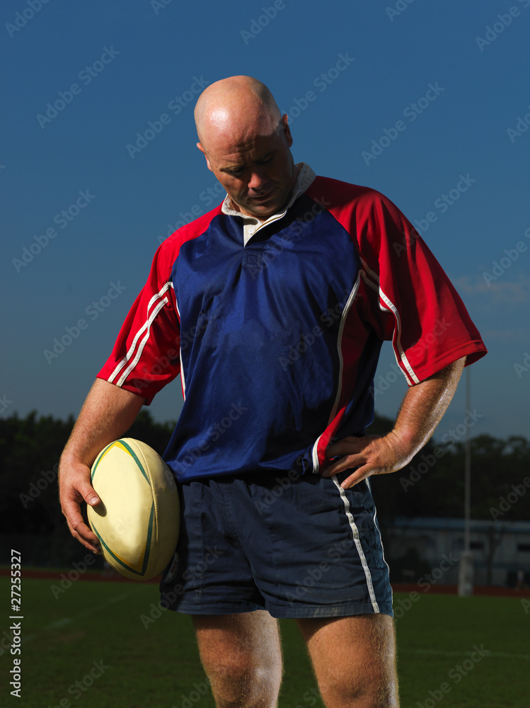 Rugby Player with his rugby ball feeling sad Stock Photo | Adobe Stock