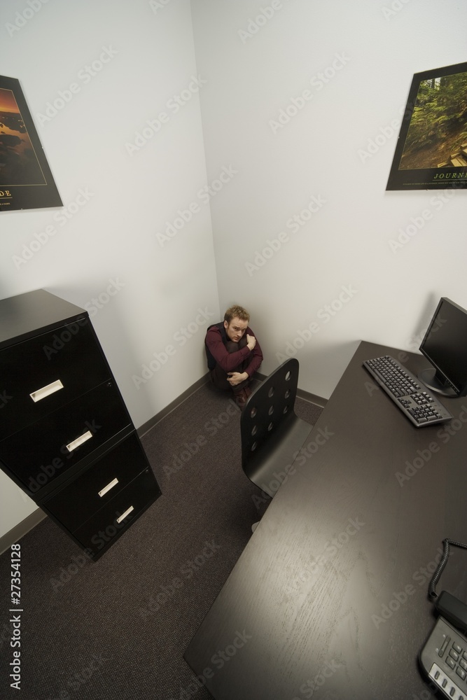 Man Cowering In Corner