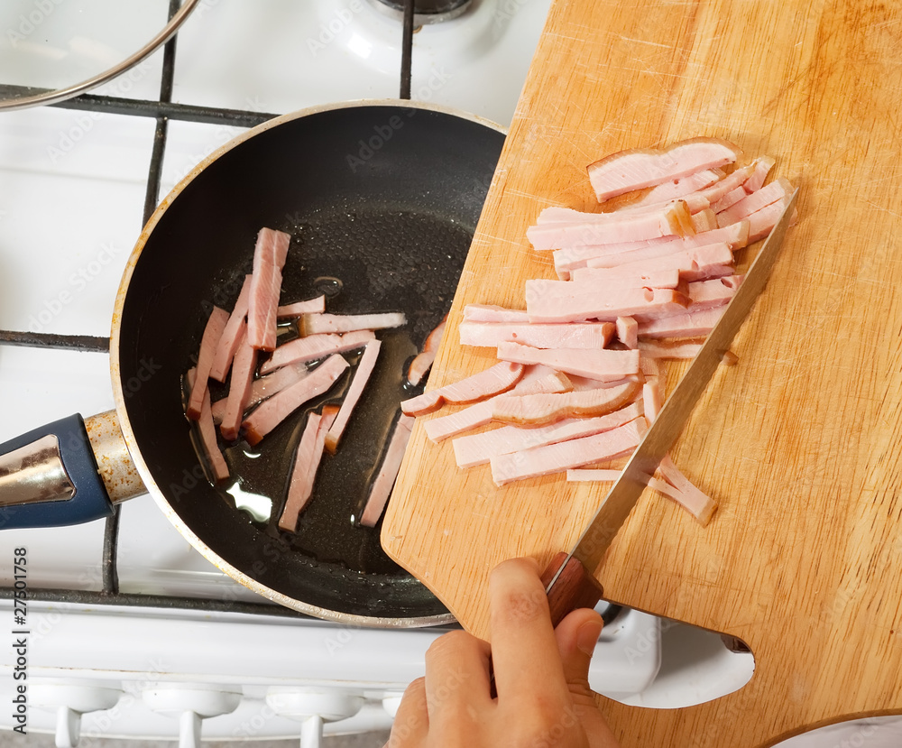 adds sliced bacon to skillet. Stages of cooking see in series Stock ...