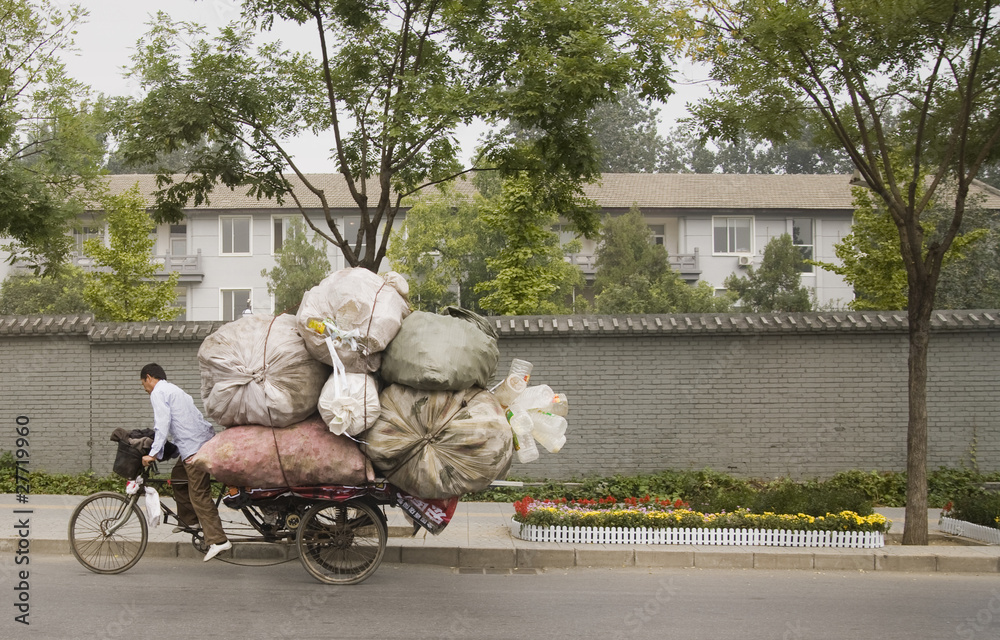 Chinese man on overloaded bike Stock Photo | Adobe Stock