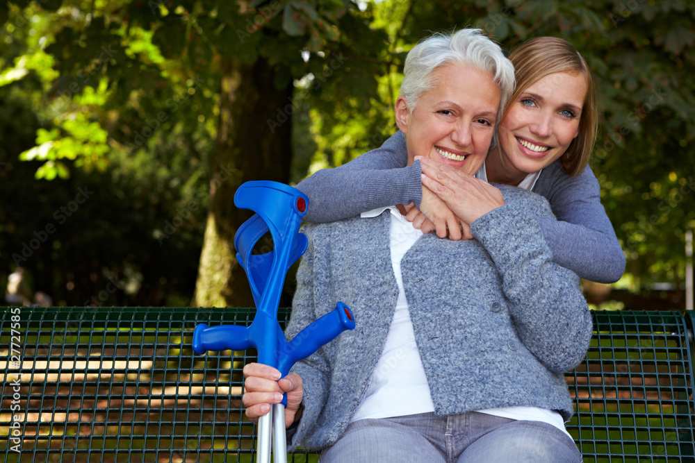 Frau umarmt Seniorin mit Krücken Stock Photo | Adobe Stock