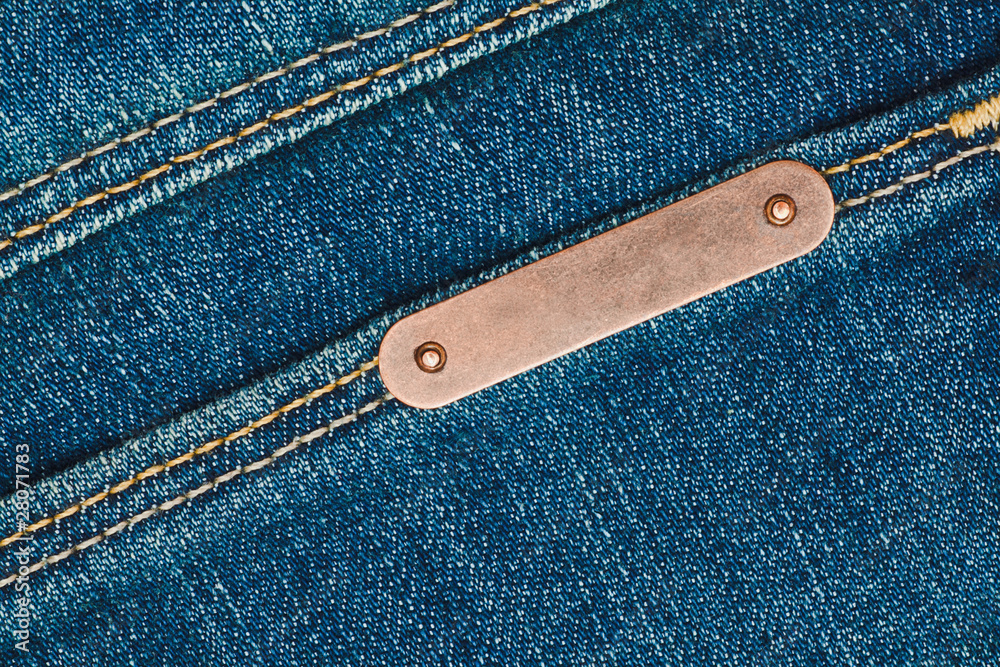 Bronze metal label on jeans Stock Photo | Adobe Stock