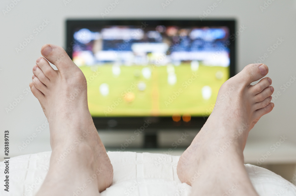 Laying in bed and watching tv between bare feet Stock Photo | Adobe Stock