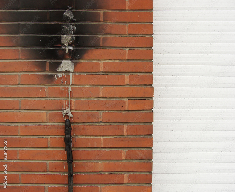 short circuit fire damage on a brick wall Stock Photo | Adobe Stock