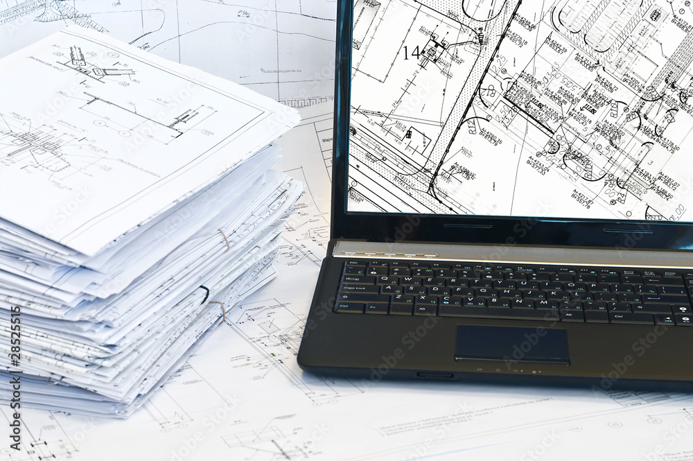Laptop and stack of project drawings. Working place. Stock Photo ...