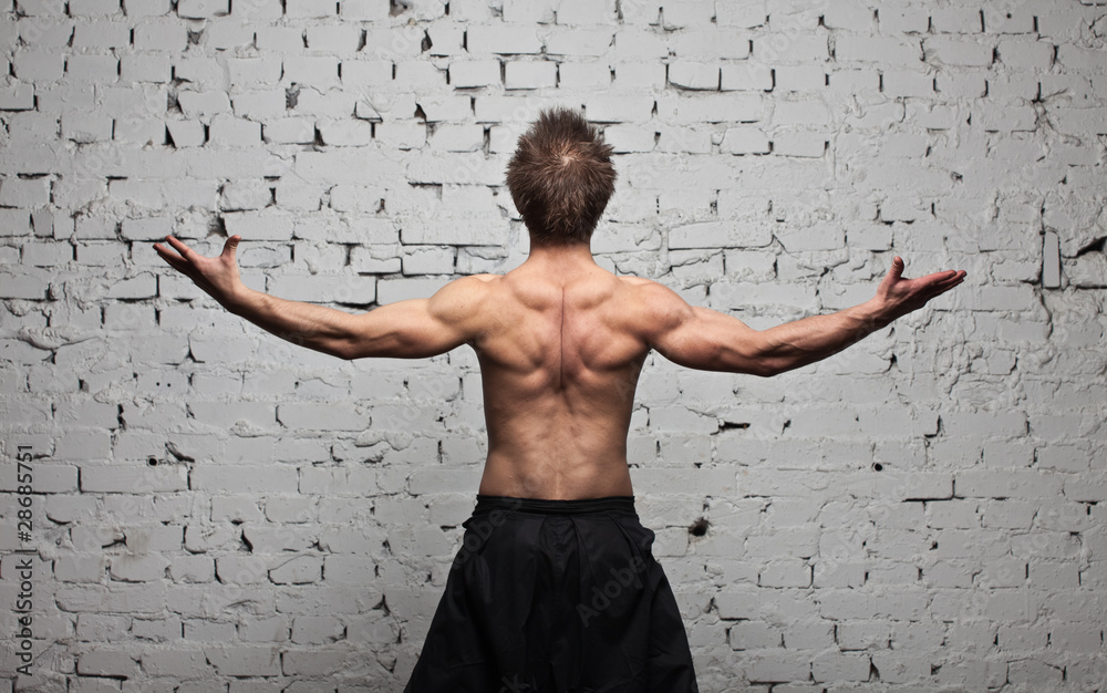Strong muscular man back in flying and free standing Stock Photo ...