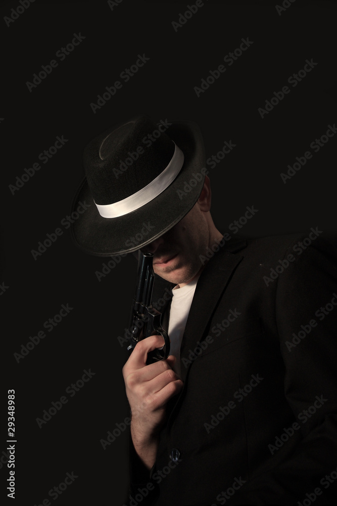elegant gangster dressed in a black suit with gun Stock Photo | Adobe Stock