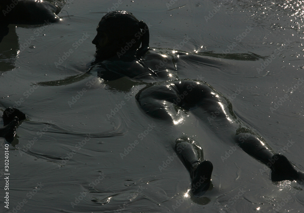The woman in mud lake Stock Photo | Adobe Stock