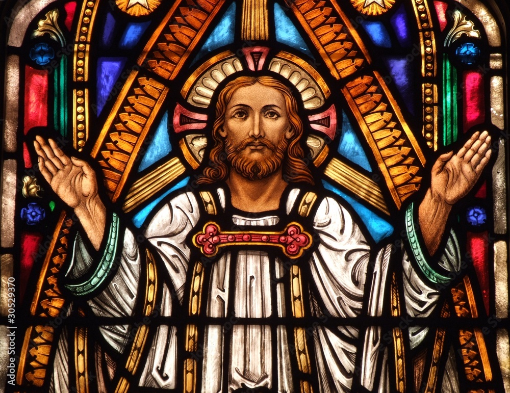 Foto de Stained Glass window of Jesus with his hands up do Stock ...