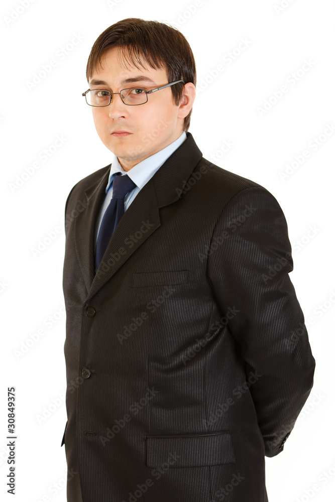 Serious young businessman holding hands behind his back Stock Photo ...