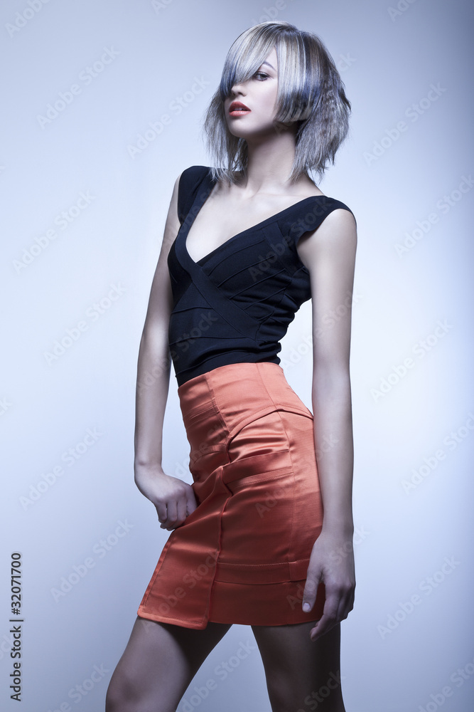 Fashion model with edgy haircut posing in studio Stock Photo | Adobe Stock