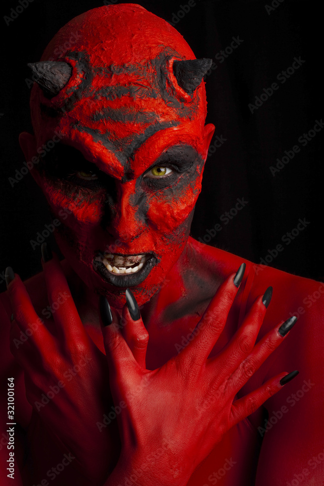Evil red devil woman. Low key lighting. Stock Photo | Adobe Stock