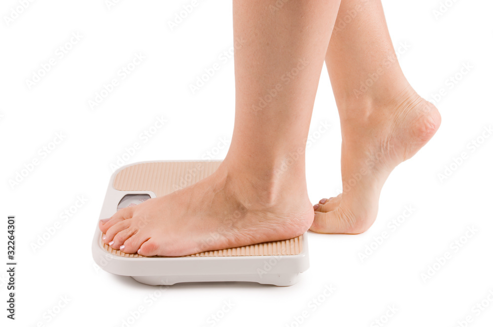 Female feet on scales isolated Stock Photo | Adobe Stock